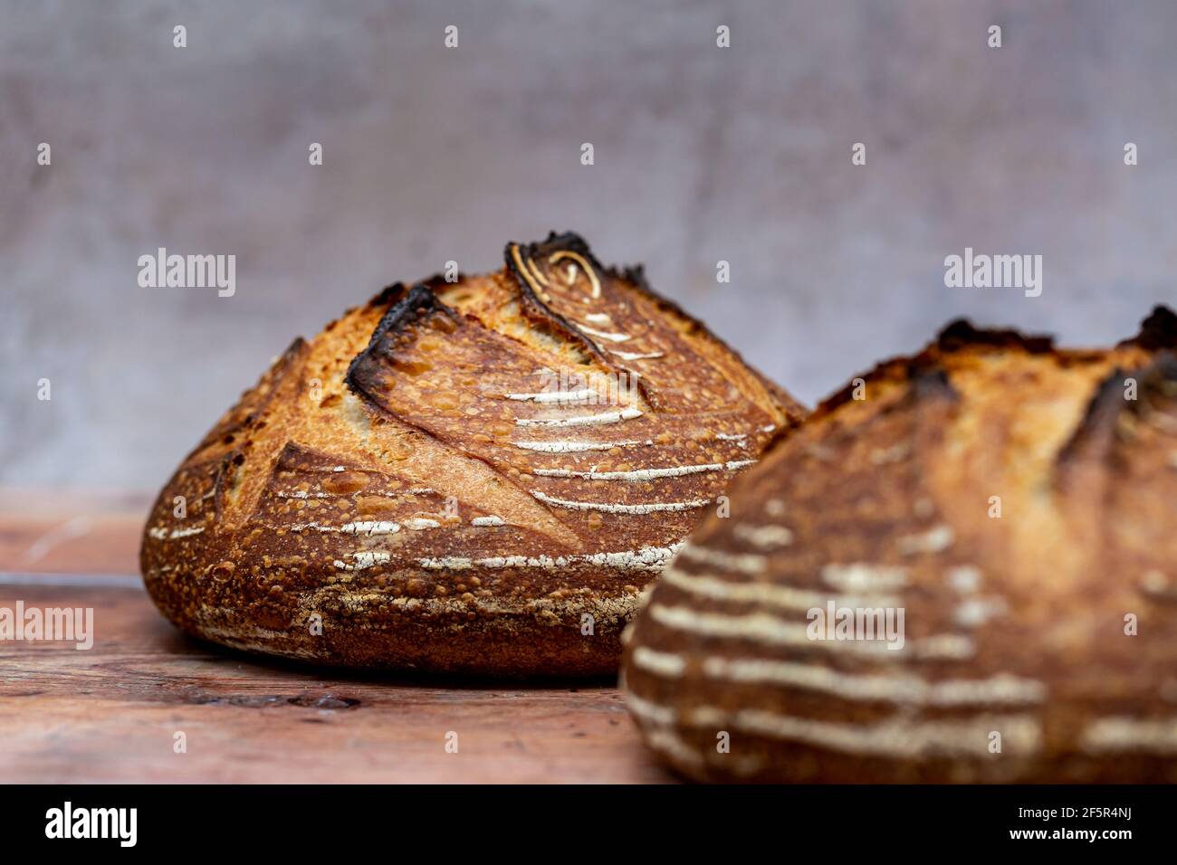 Two loaves of sourdough bread, with a shallow depth of field Stock ...
