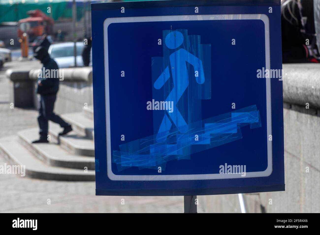 A blue road sign of entrance to the underpass, symbol for subway or ...