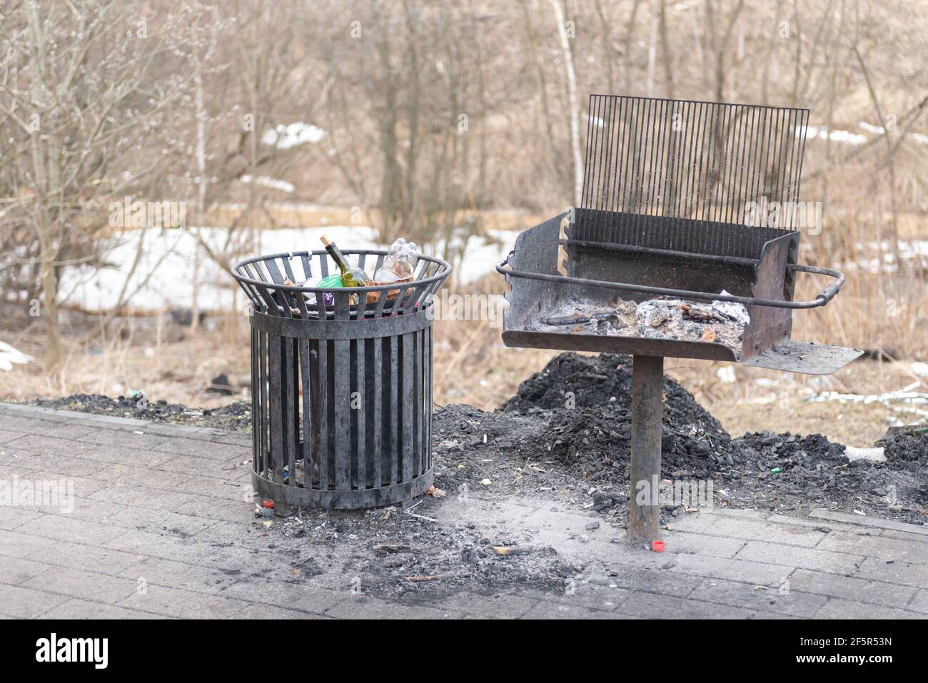 City grill in the park. A much-worn public city grill. Garbage and ash ...