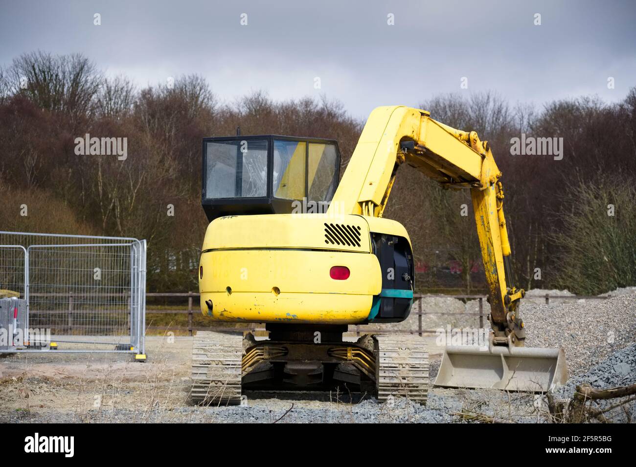 Construction site digger yellow during excavation on building site ...