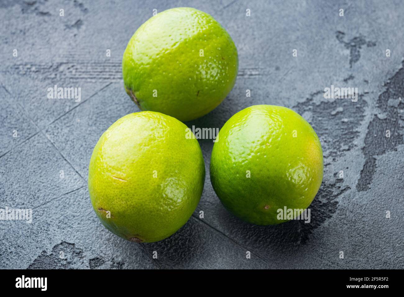 Whole green lime set, on gray background Stock Photo - Alamy
