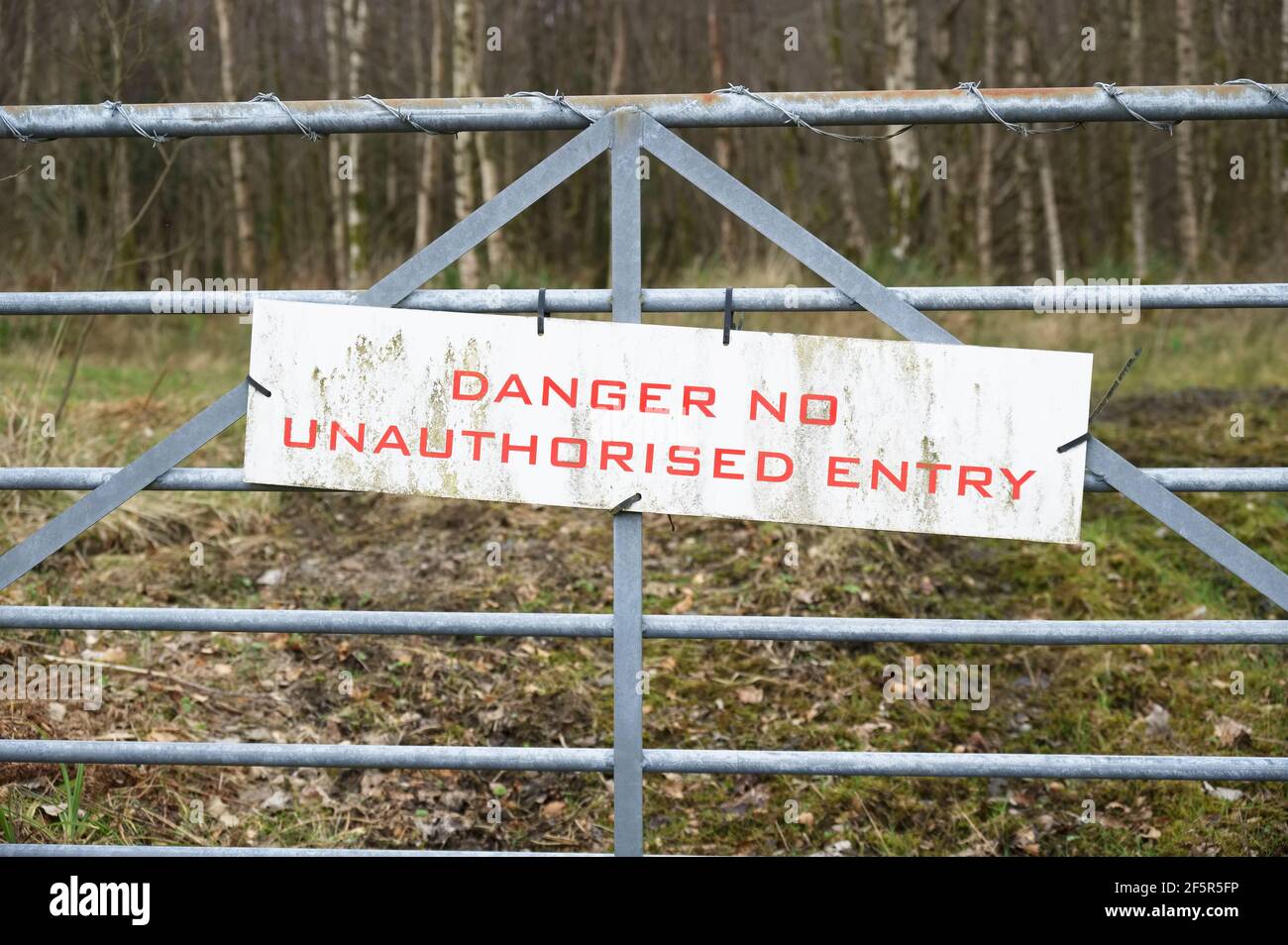 Danger no unauthorised entry sign on gate Stock Photo - Alamy