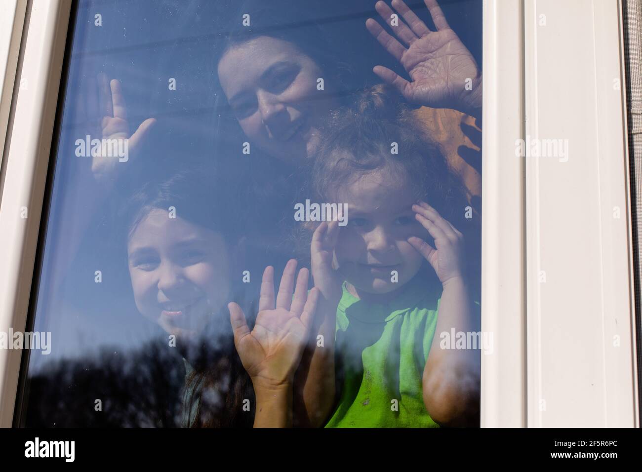 the children stay near the window and enjoy the weather Stock Photo - Alamy