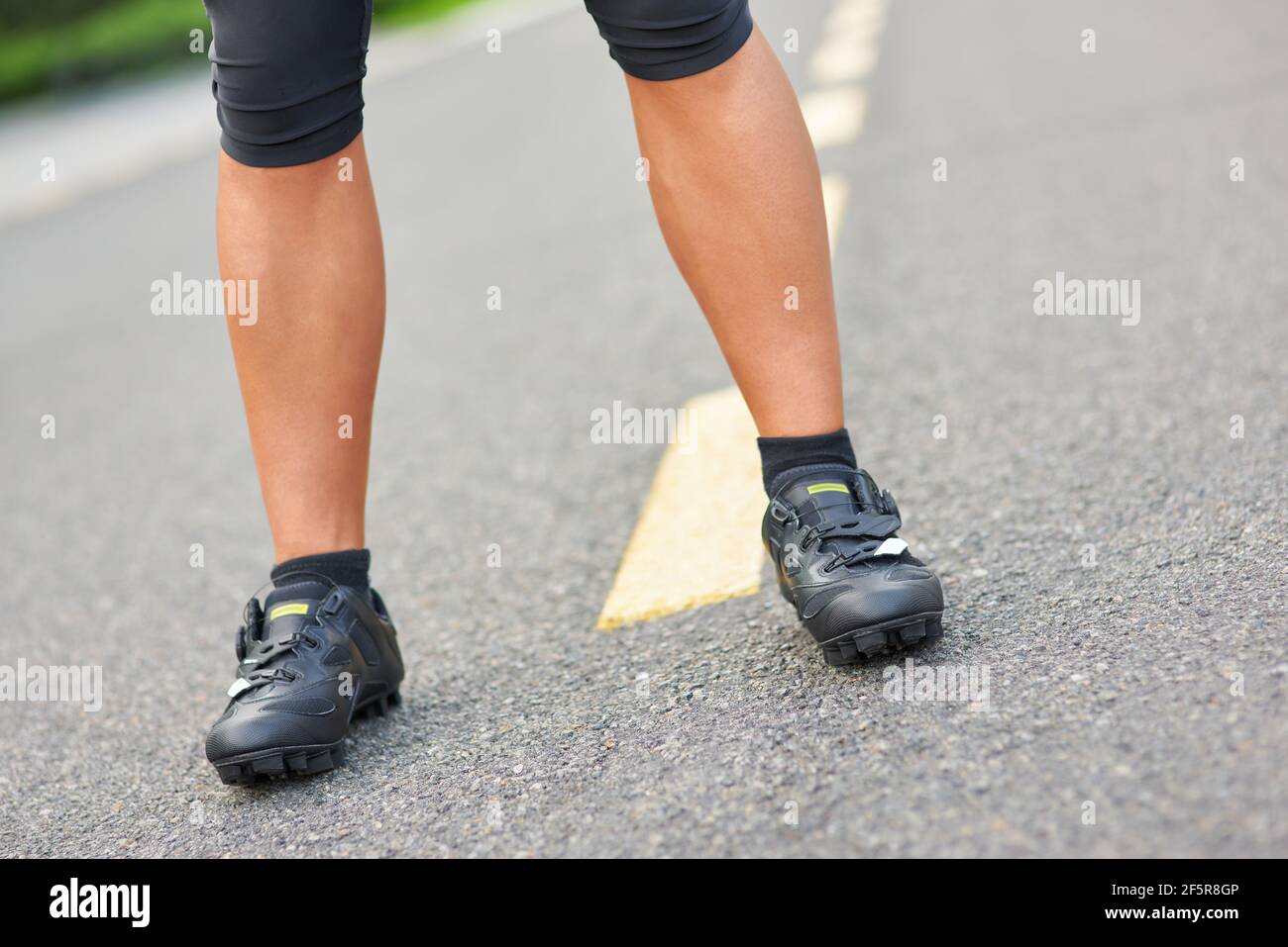 Close up shot of legs of professional male cyclist wearing cycling ...