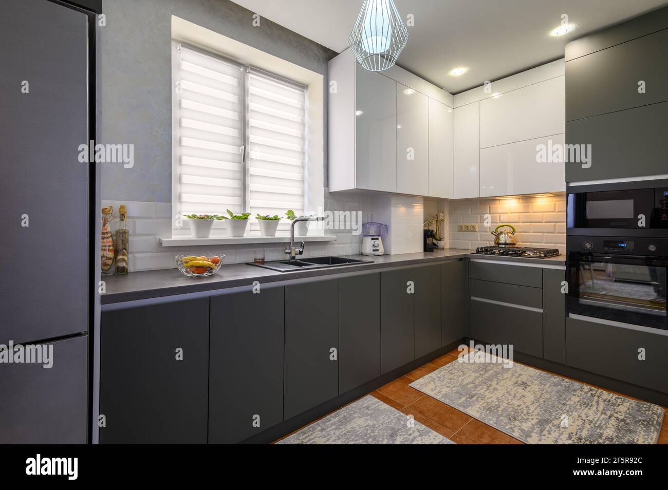 Modern dark grey small kitchen interior Stock Photo - Alamy