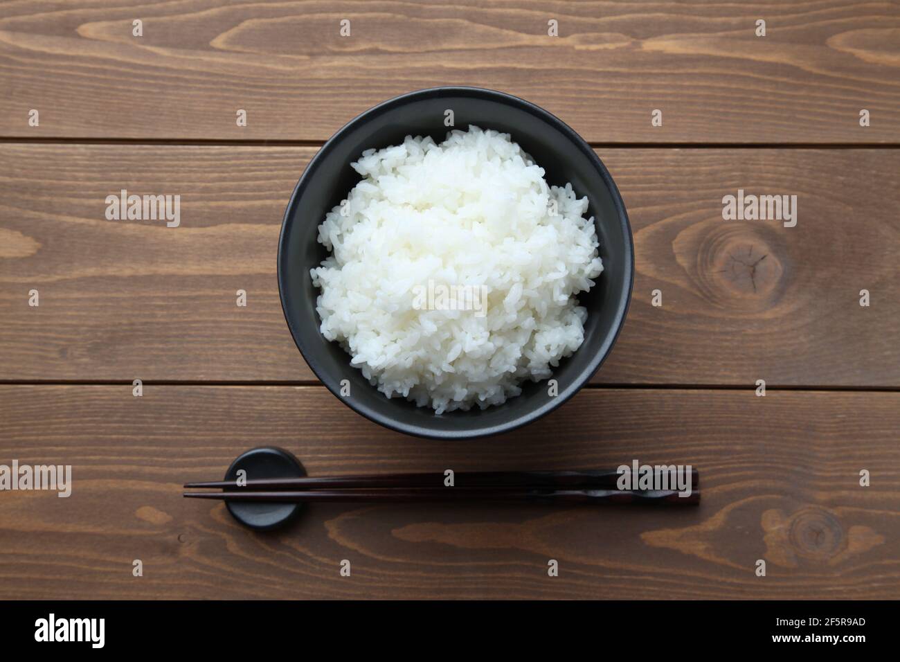 plain white rice in bowl with chopsticks isolated on table Stock Photo ...