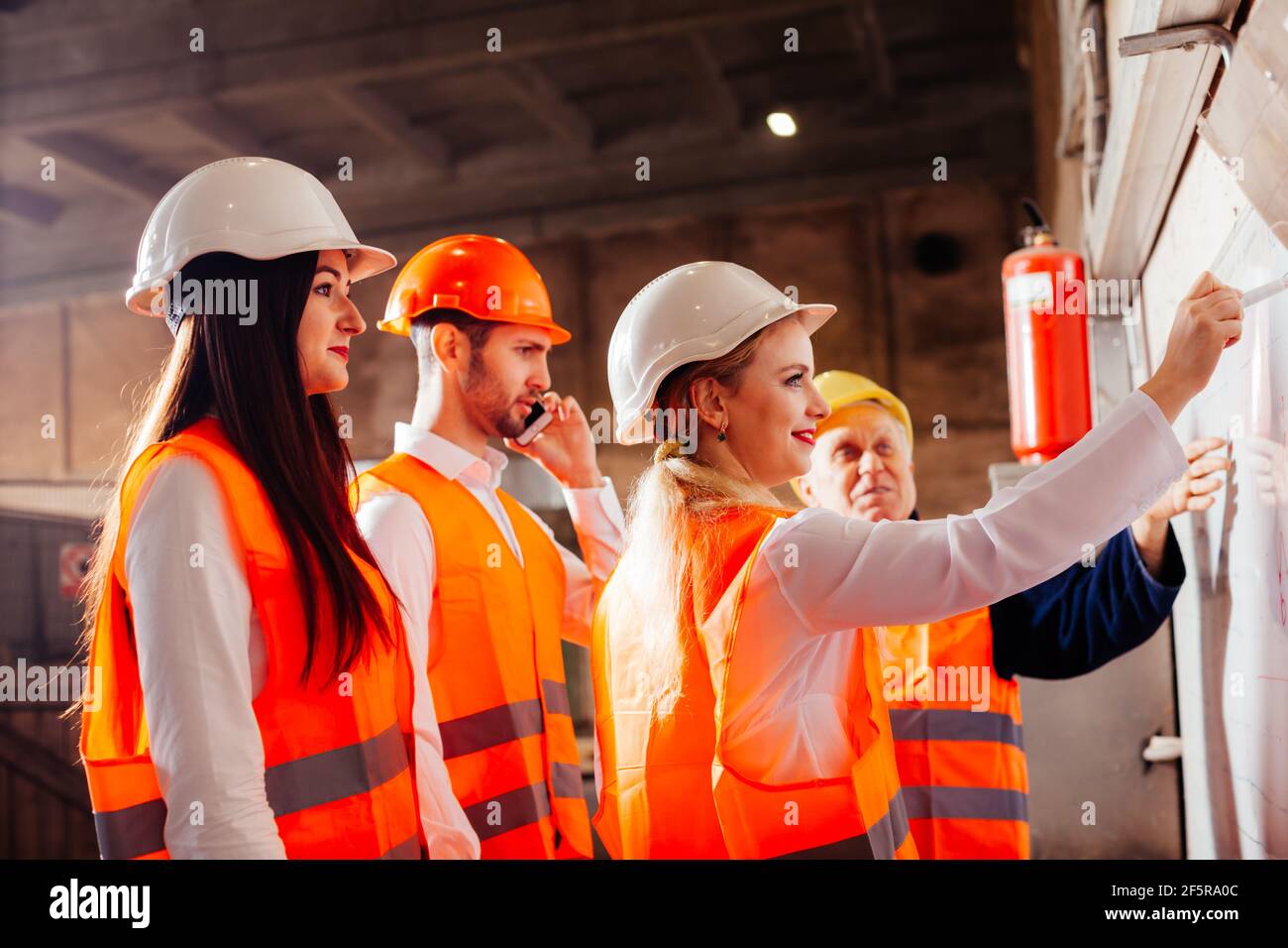 The workers draw up a plan of work at the plant Stock Photo - Alamy