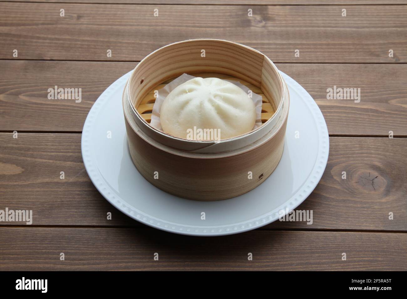 steamed meat bun baozi on wooden table Stock Photo - Alamy