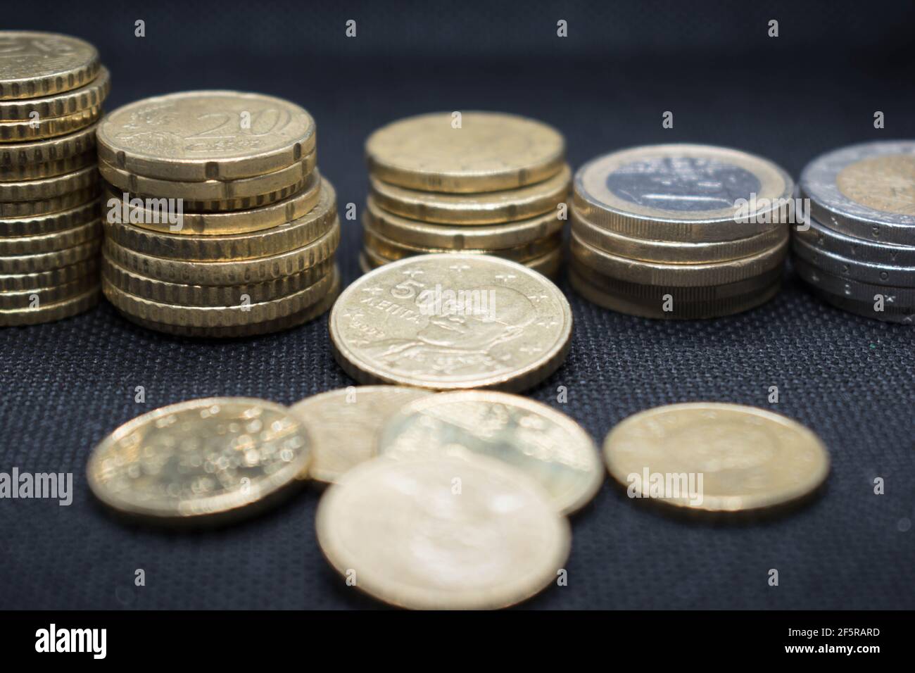 Euro Coins stacks on black background in different positions.Euro coins ...