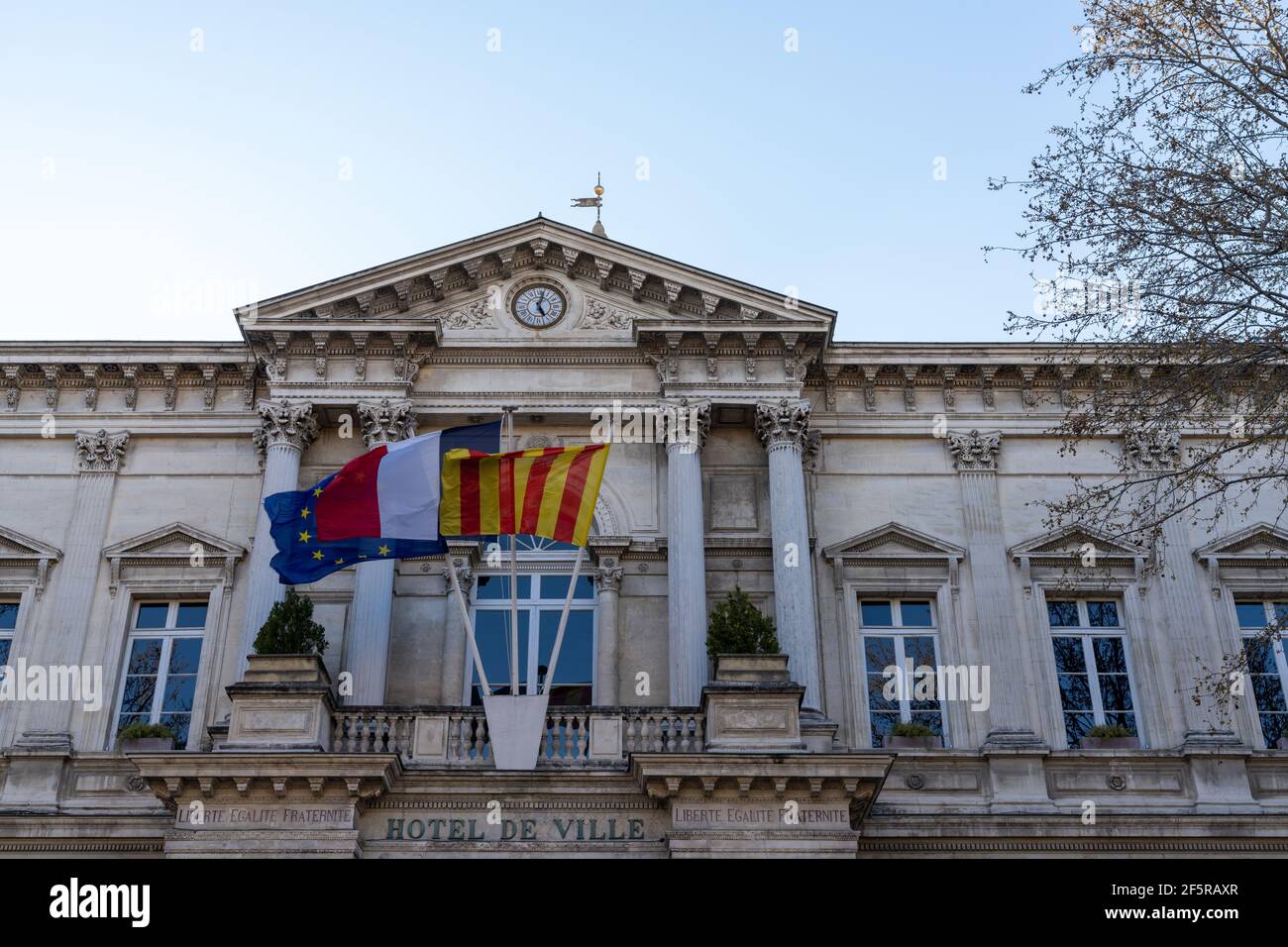 Avignon, France - 18 March, 2021: city hall building with flags of ...