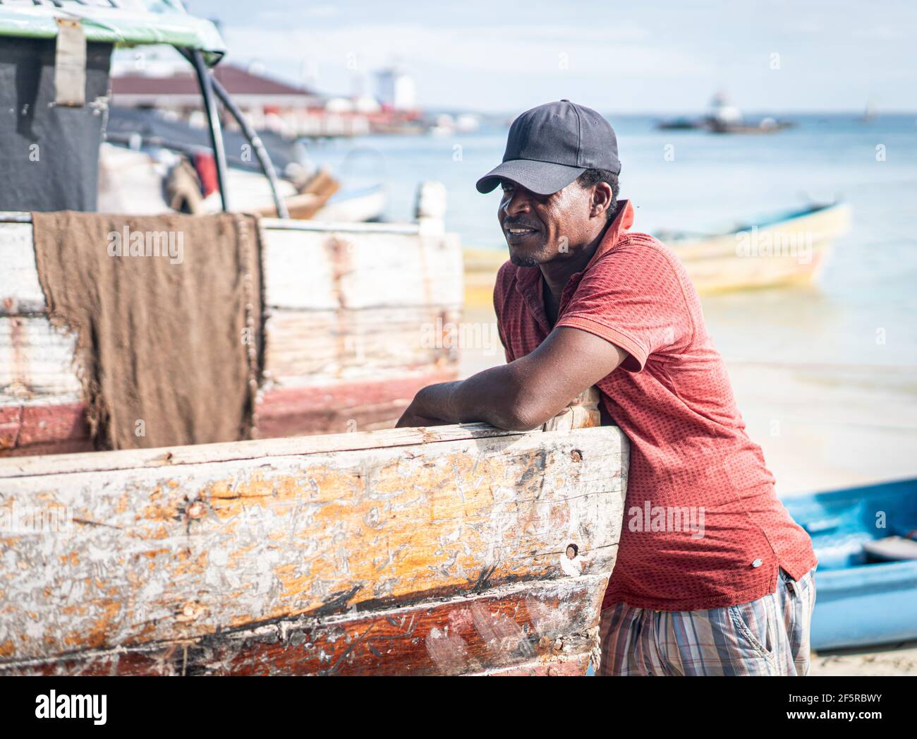 Candid black fisherman on coast ocean Stock Photo - Alamy