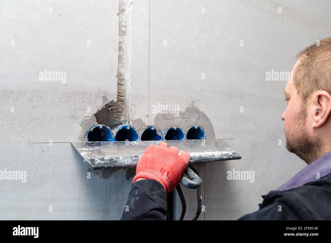 The electrician will plaster holes and channels for sockets and wires ...