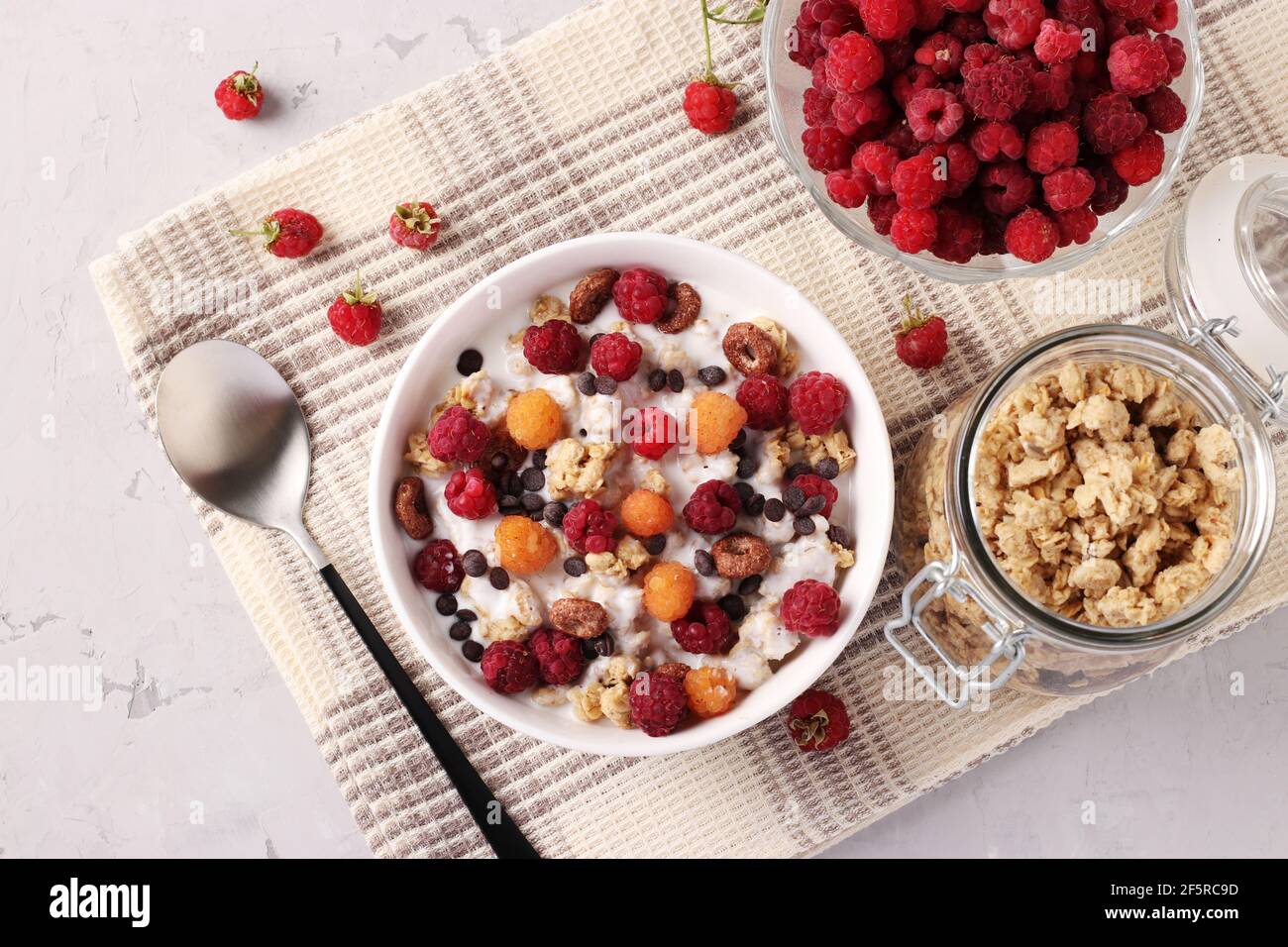 Granola crispy with natural yogurt, fresh red and yellow raspberries ...
