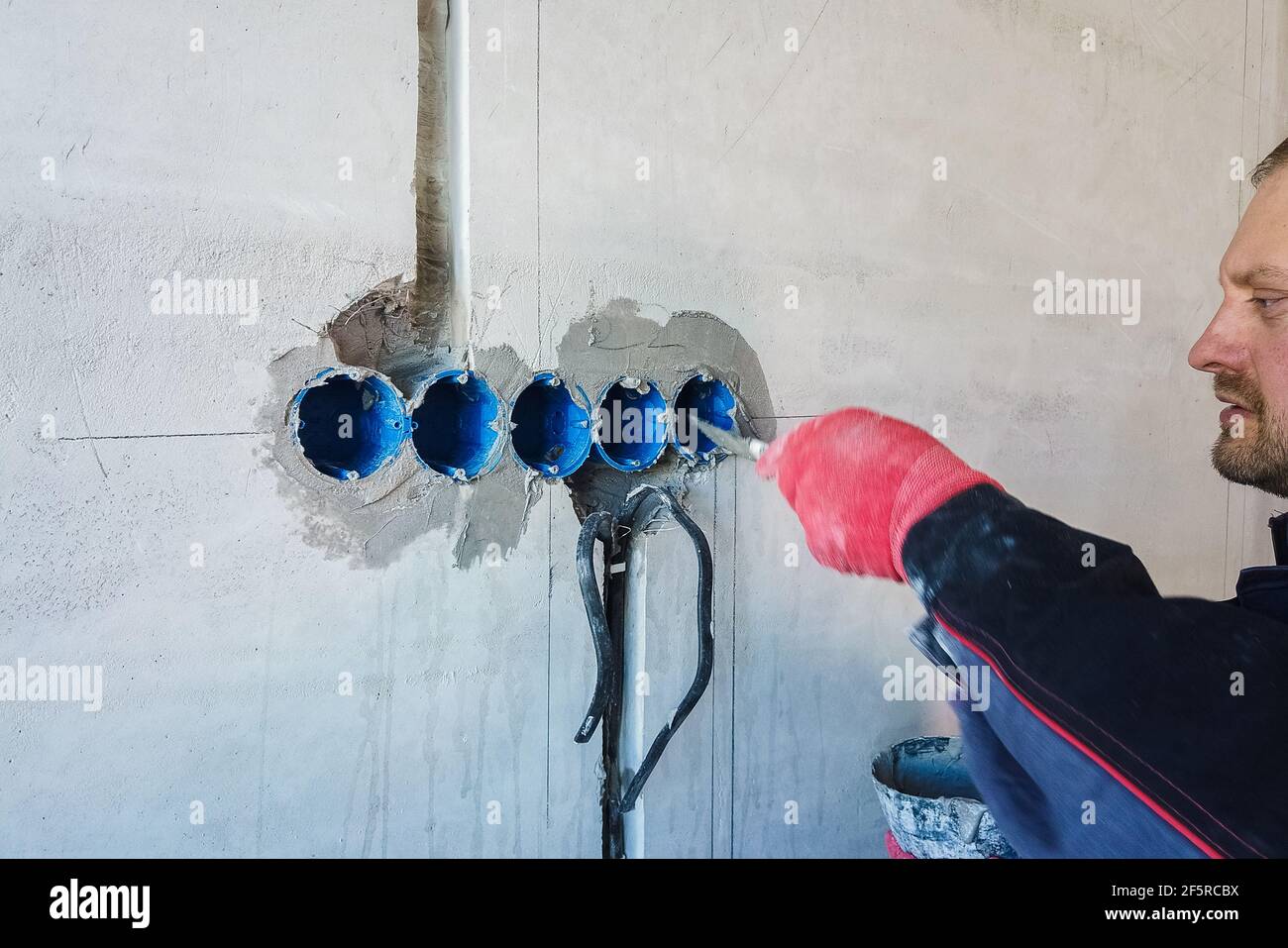 The electrician will plaster holes and channels for sockets and wires ...