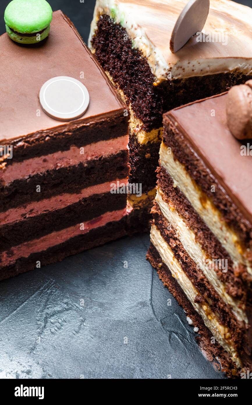 The quarters of different cakes with macaroons on the top Stock Photo ...