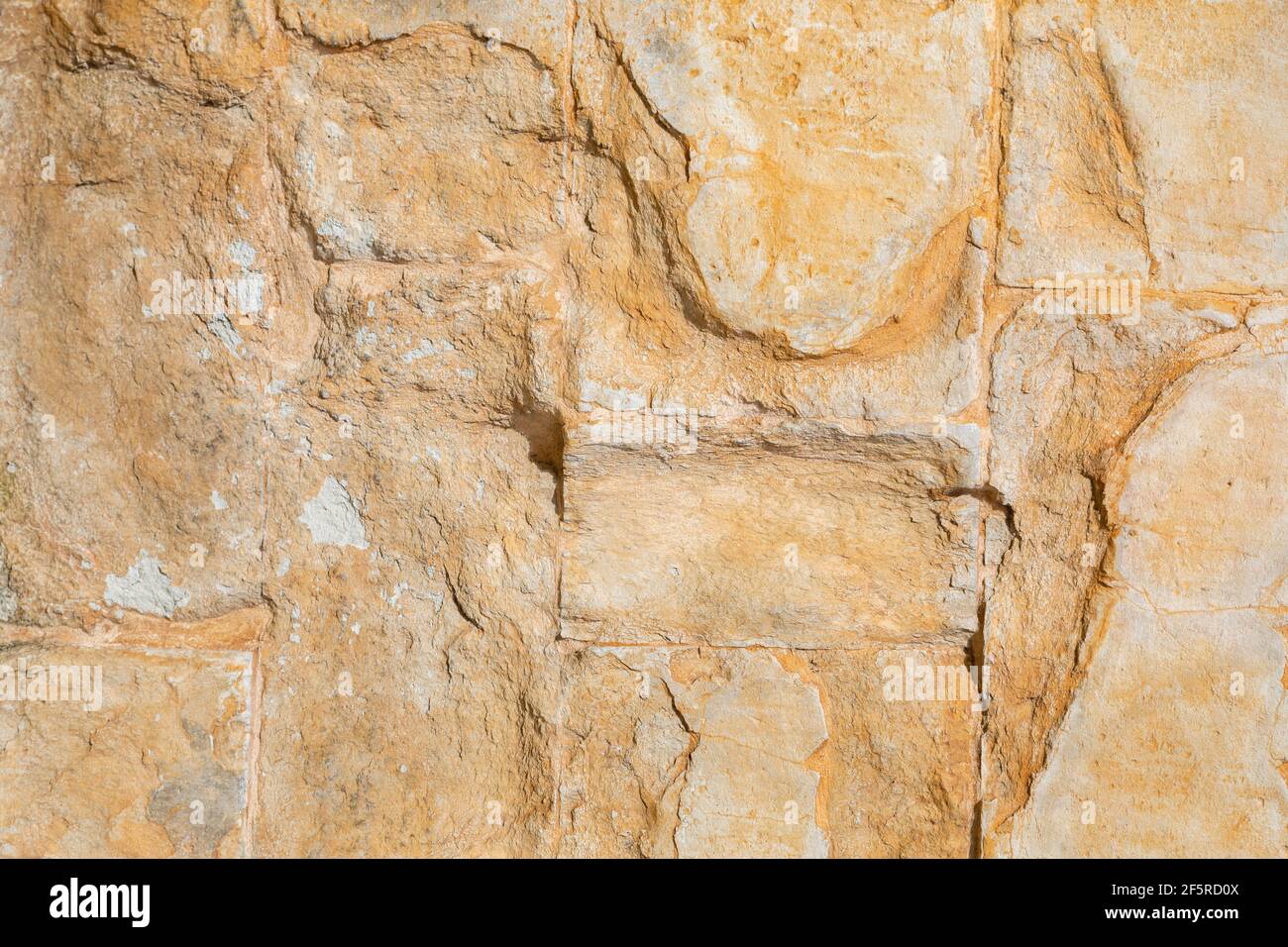 golden yellow stone wall, background texture Stock Photo - Alamy