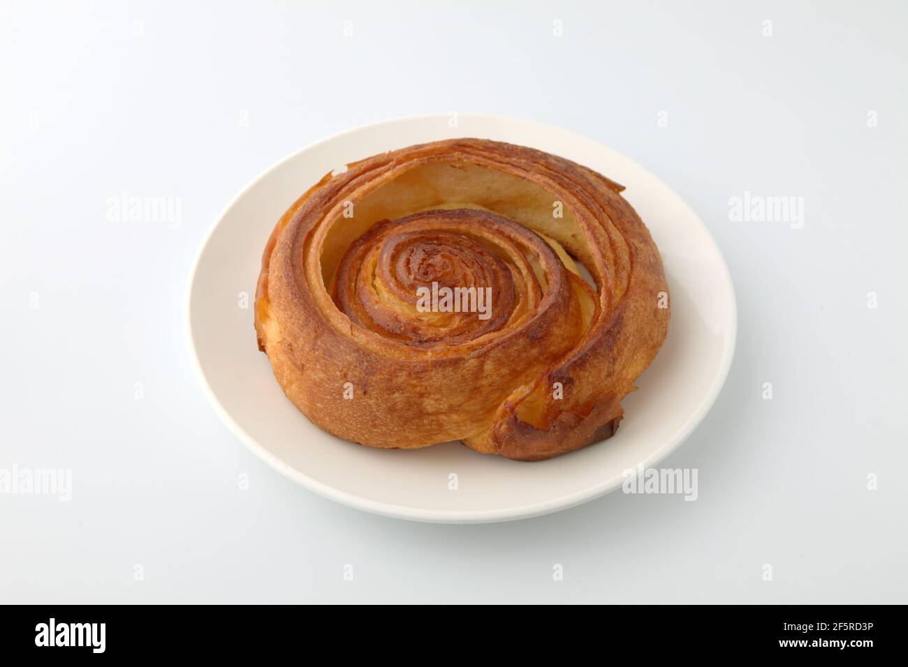 round danish bread on plate isolated on white background Stock Photo ...
