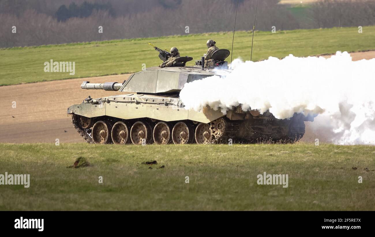 British Army Challenger 2 main battle tank throws out a white diesel ...