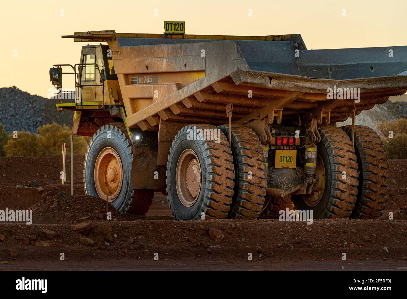 Dump trucks at sunset on mining Go Line in open pit mining area Stock ...