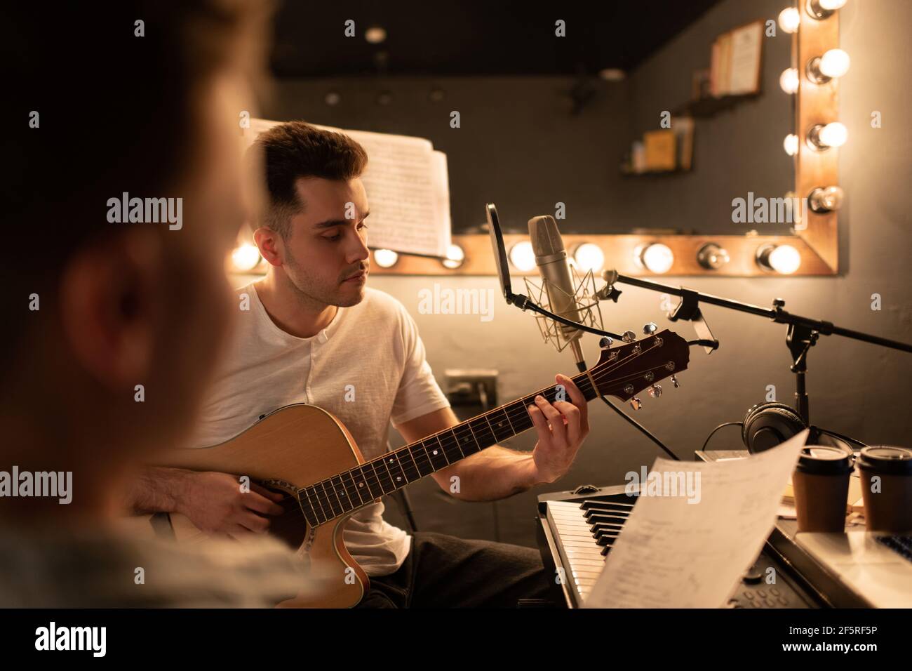 Men creating music in studio together Stock Photo - Alamy