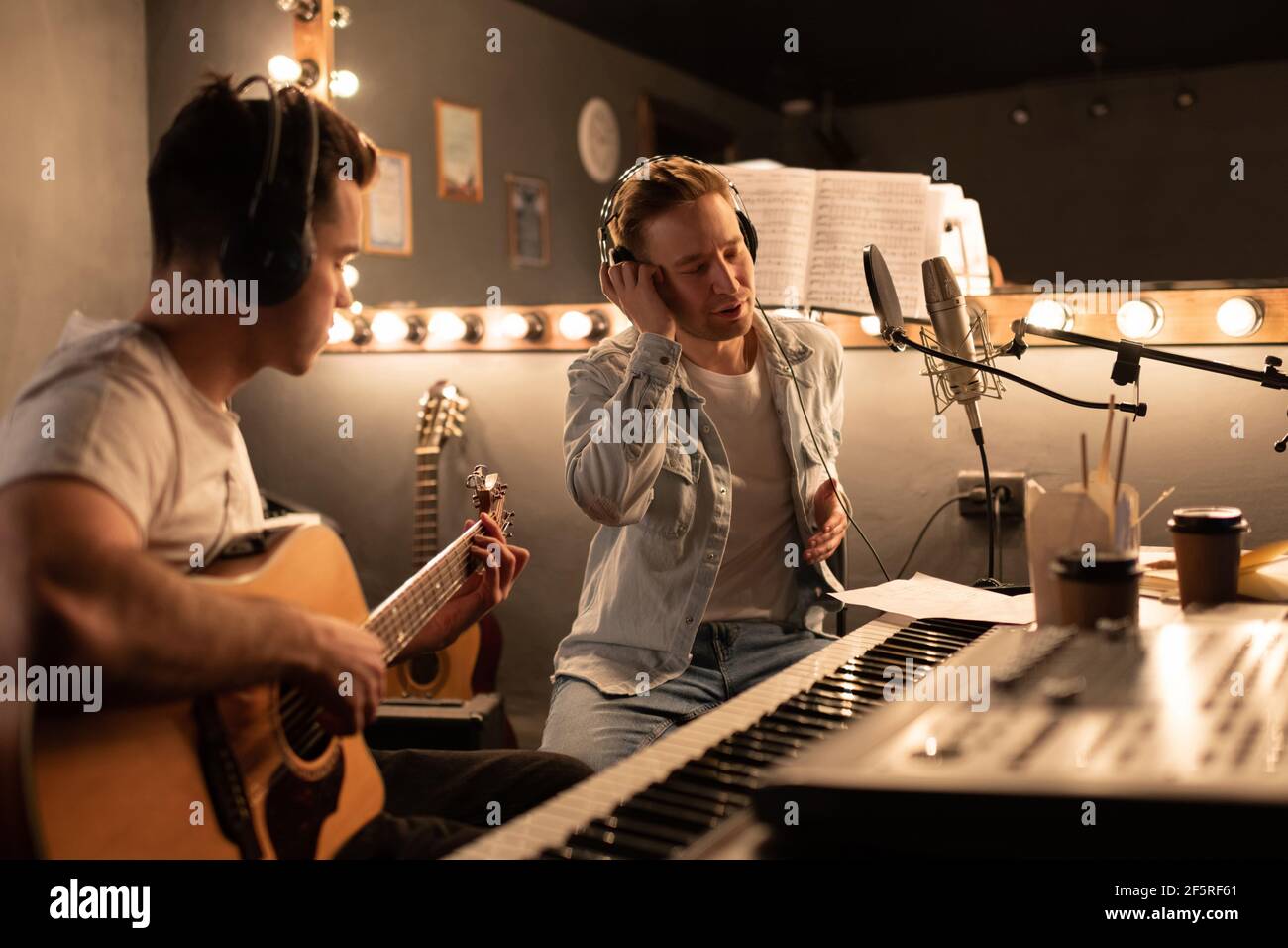 Men creating song in modern studio Stock Photo - Alamy