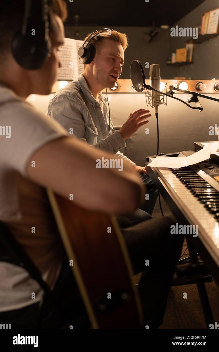 Professional musicians creating song in recording studio Stock Photo ...
