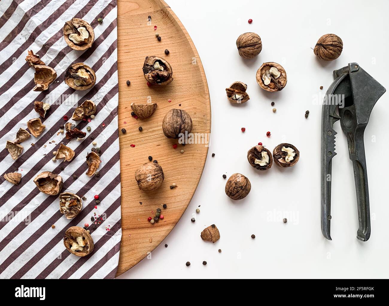 Cracked walnuts on a wooden board and white background Stock Photo - Alamy