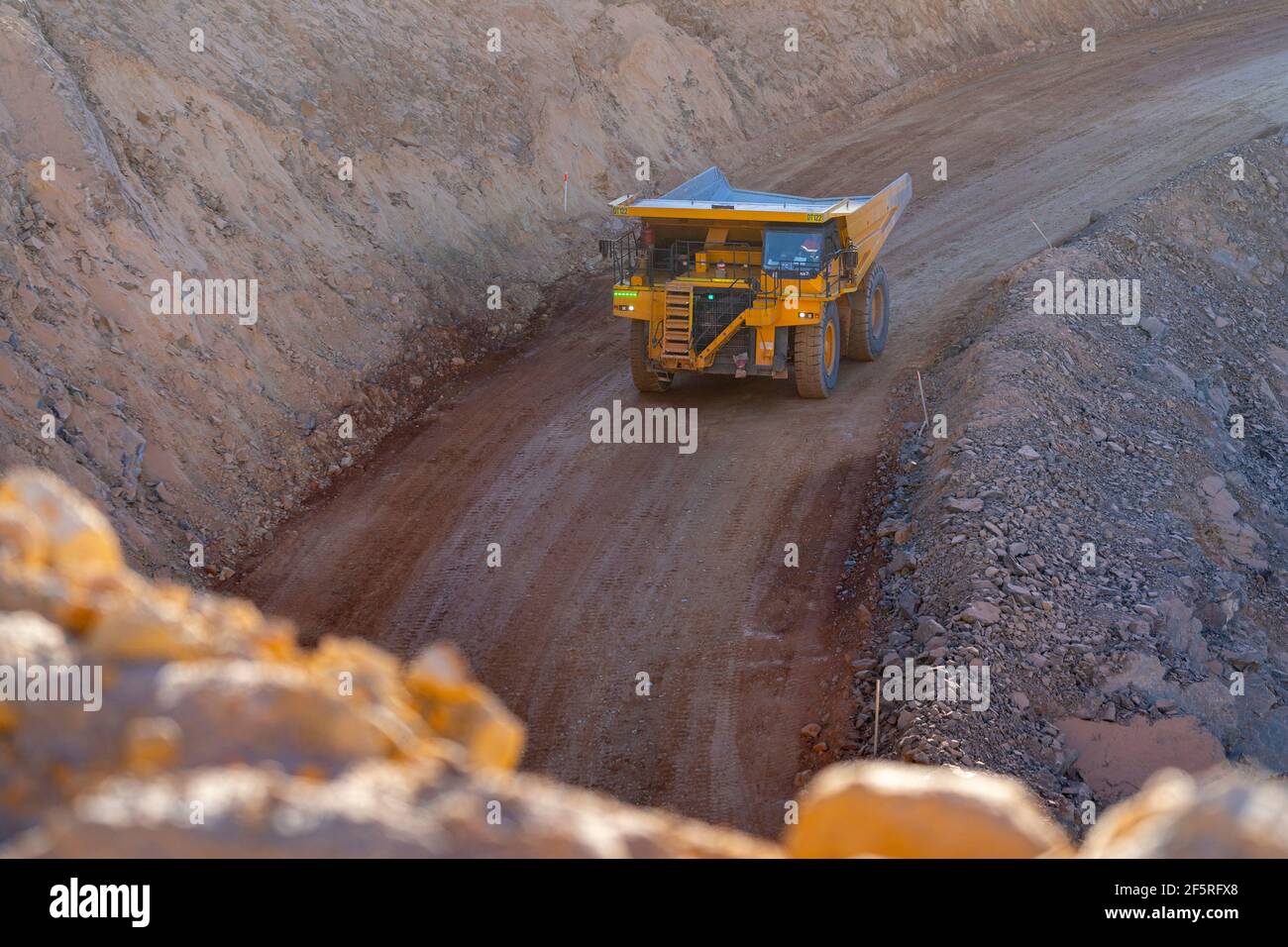Dump Truck at open pit mine transporting ore on haul road Stock Photo ...