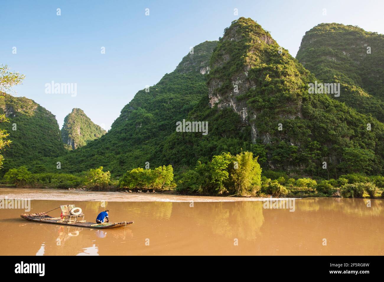 fisherman on traditional raft on the Yulong river close to Yangshuo ...