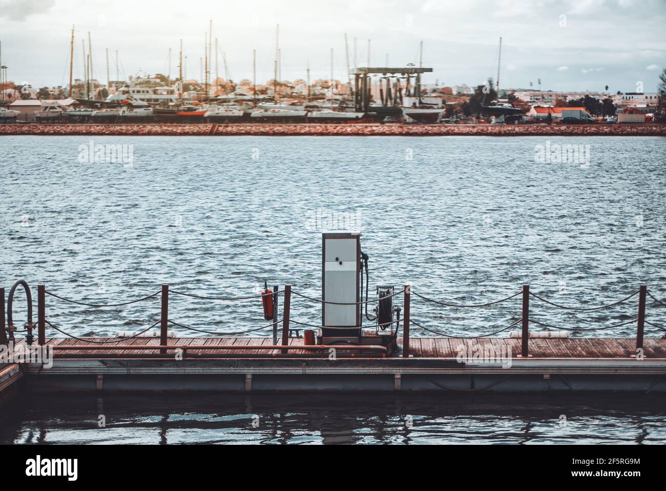 A fuel dispenser at boat filling station on the floating pier with ...