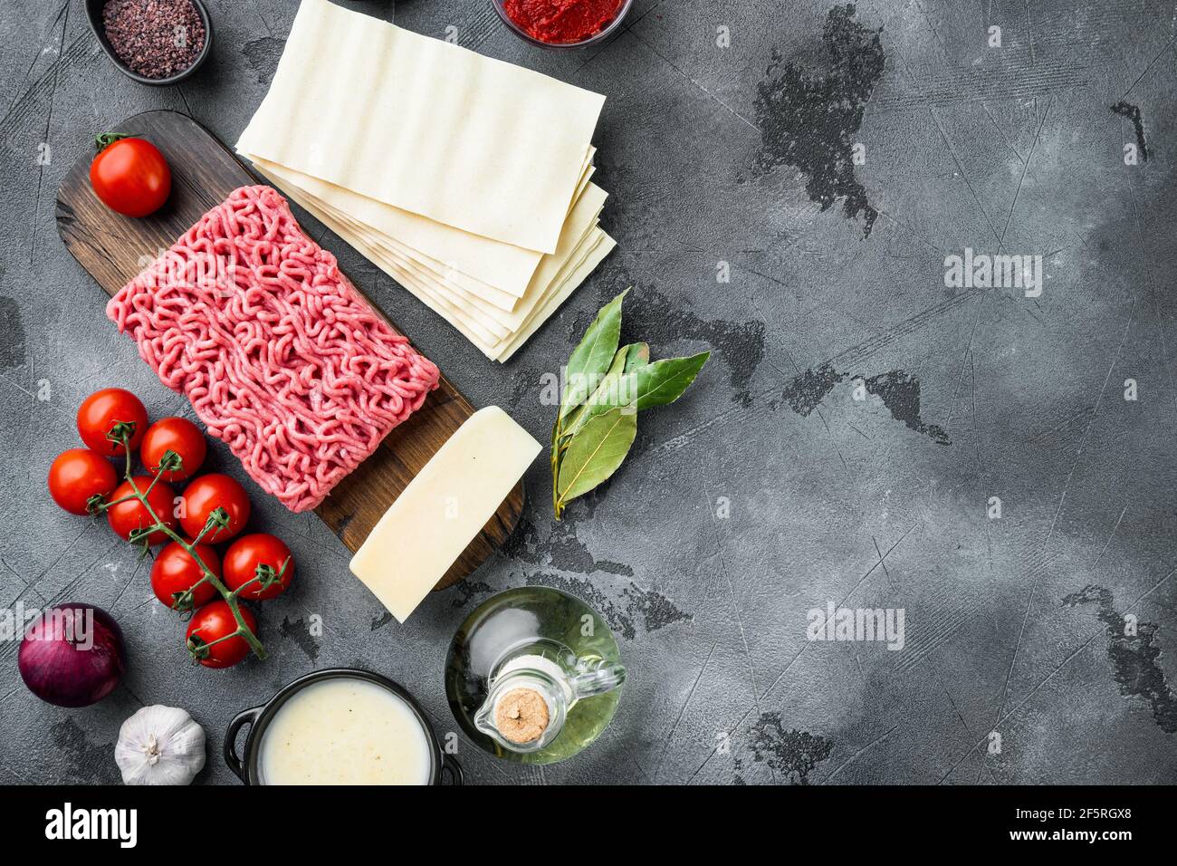 Different ingredients for lasagna set, on gray stone background, top ...