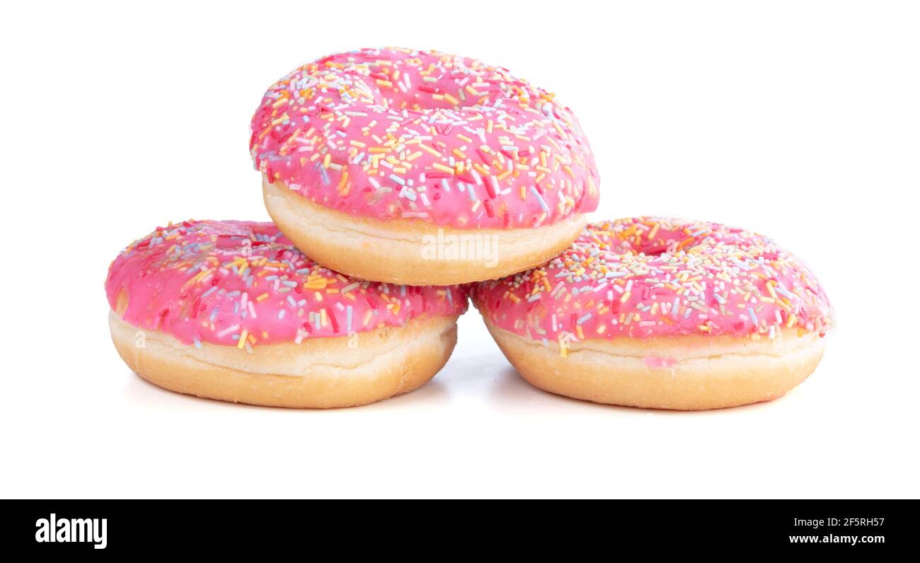 Three pink donuts with small candies on a white background Stock Photo ...