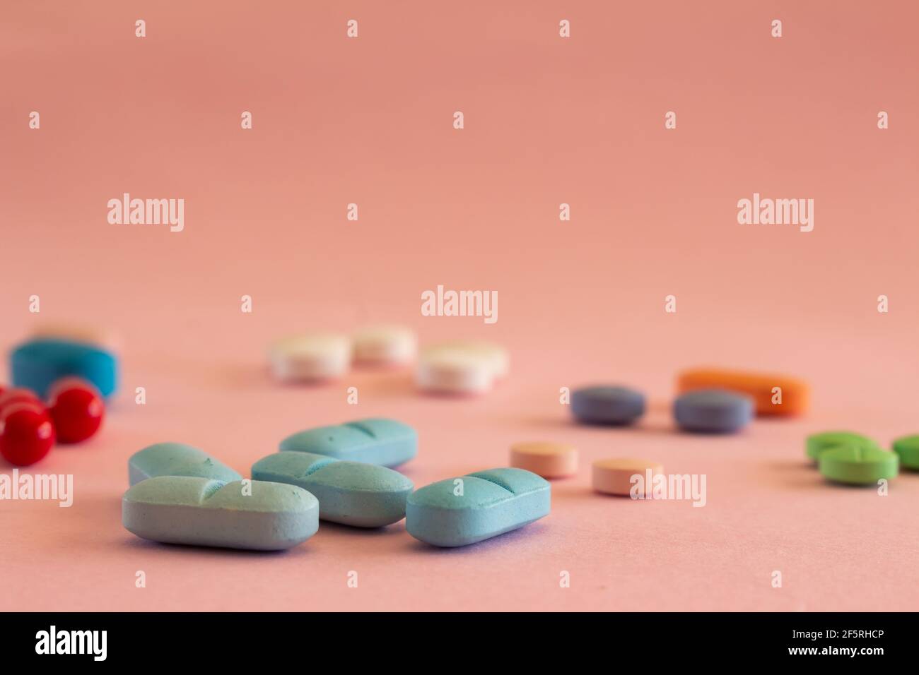 Pills of colors on neutral background. Legal drugs from the ...