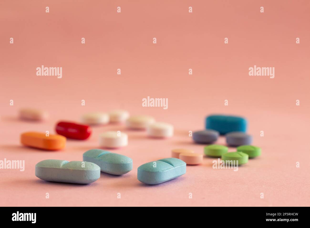 Pills of colors on neutral background. Legal drugs from the ...