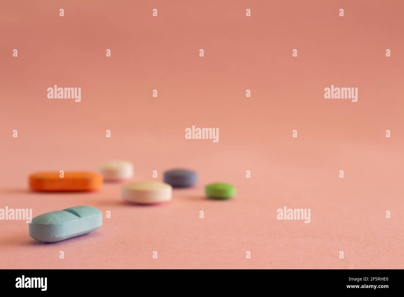 Pills of colors on neutral background. Legal drugs from the ...