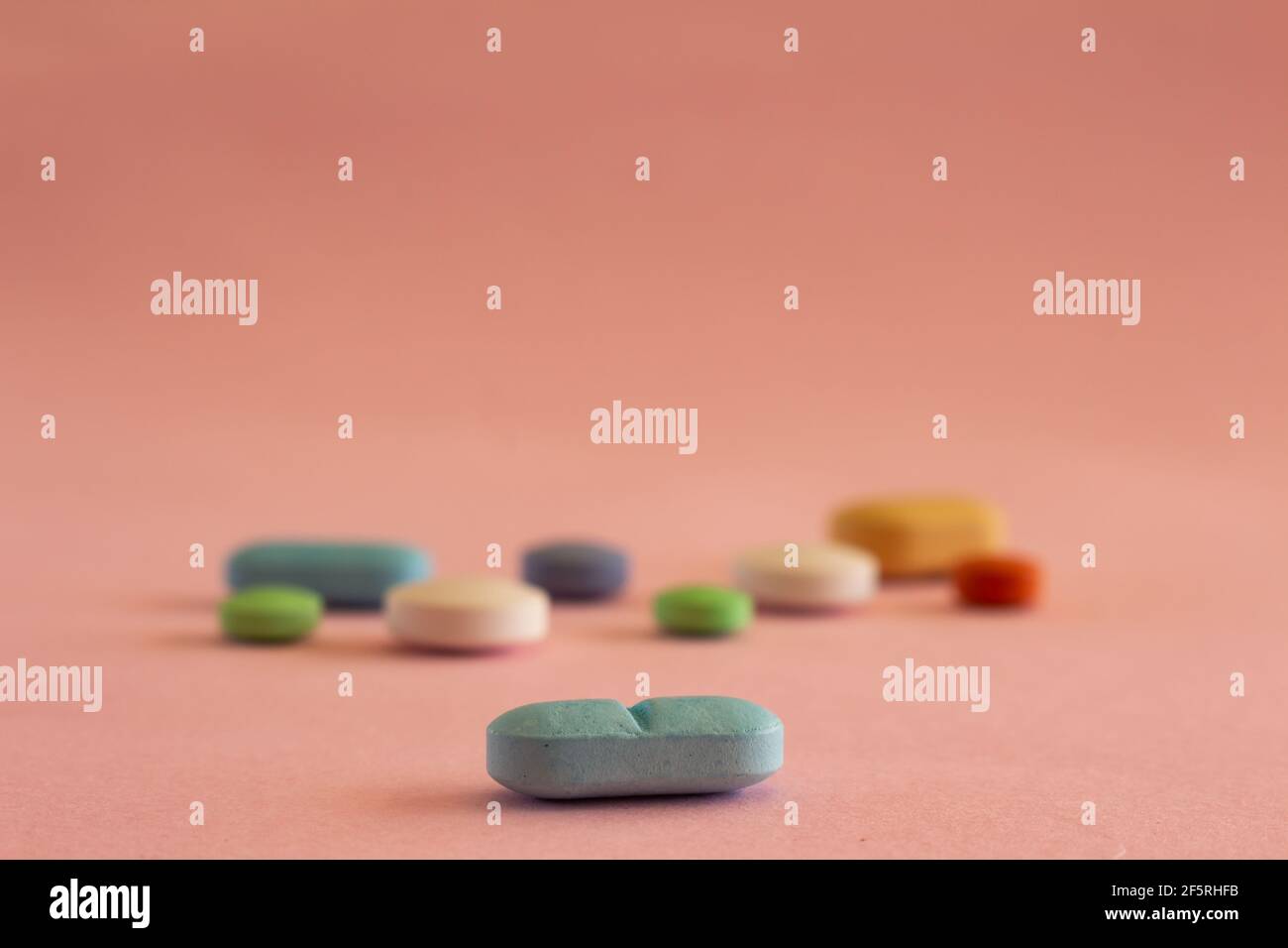 Pills of colors on neutral background. Legal drugs from the ...