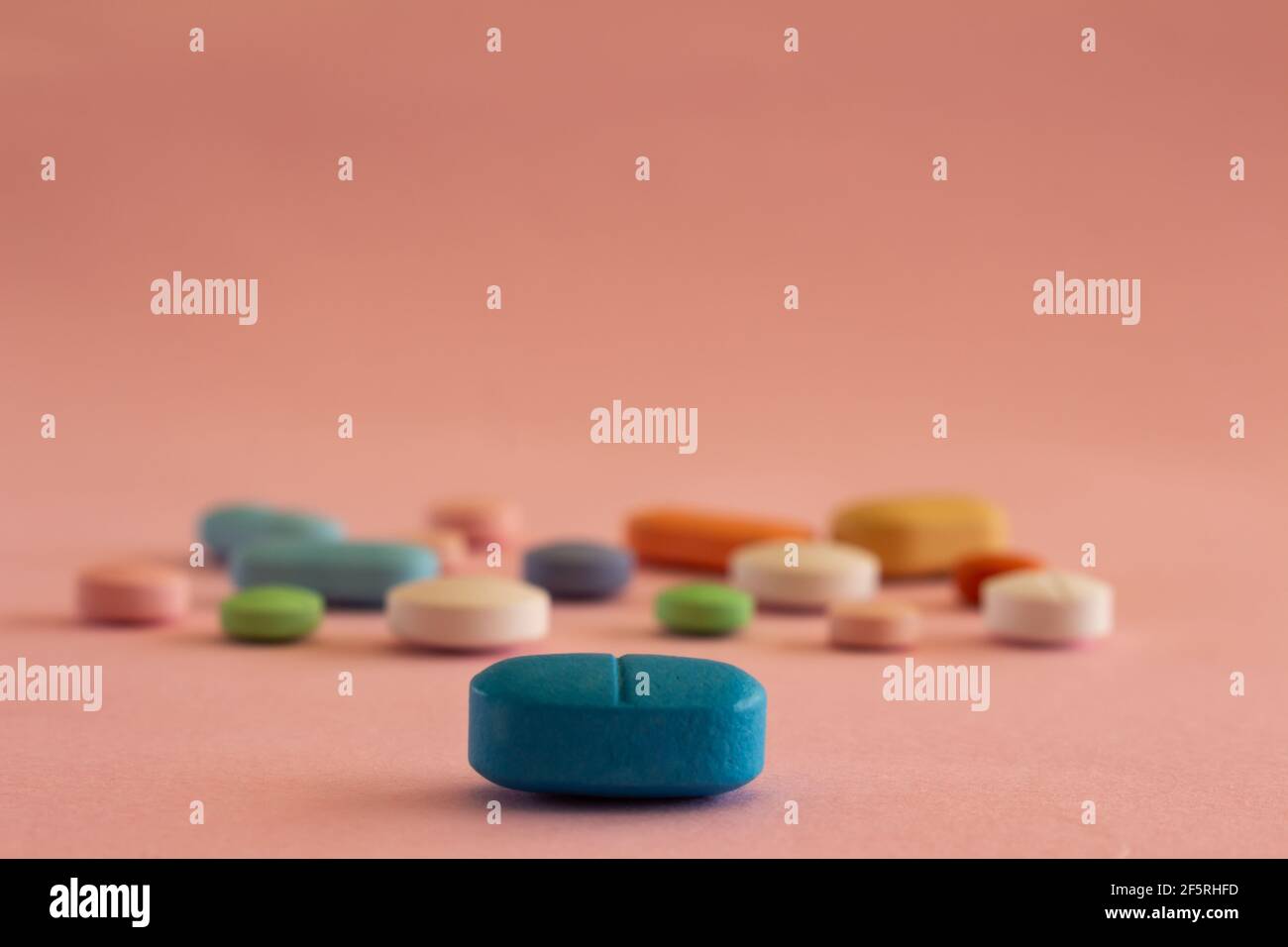 Pills of colors on neutral background. Legal drugs from the ...