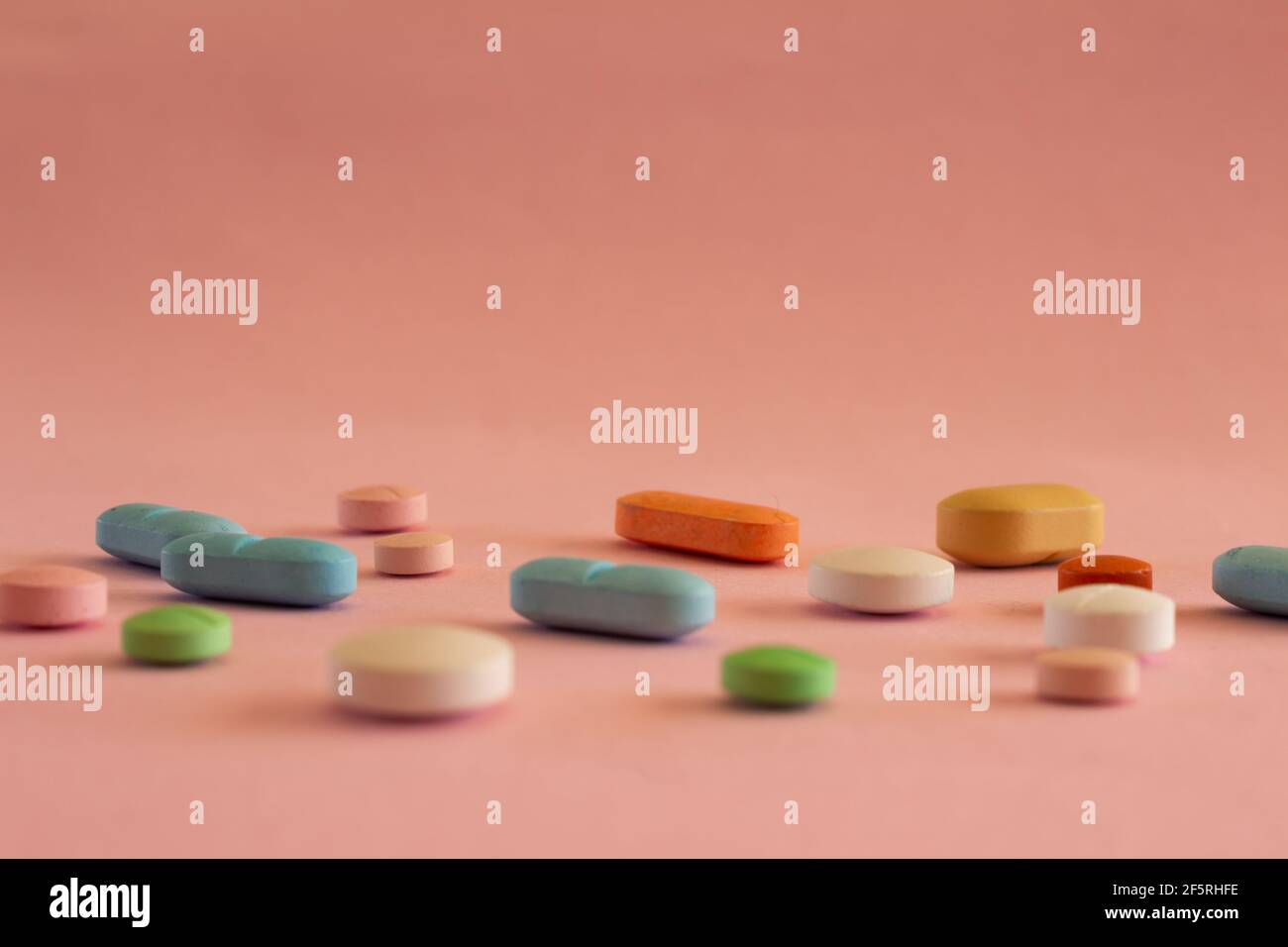 Pills of colors on neutral background. Legal drugs from the ...