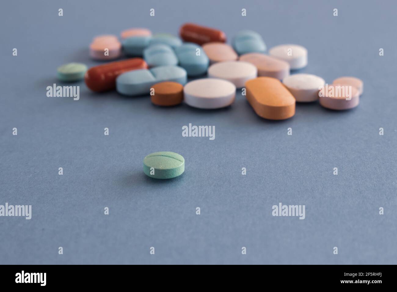 Pills of colors on neutral background. Legal drugs from the ...