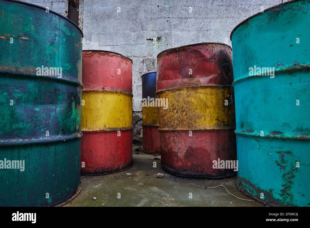 Abandoned and rusty barrels of gasoline, oil in an attractively colored ...