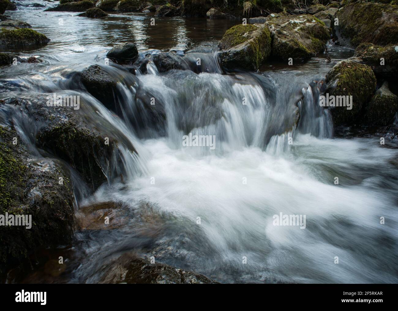 Fast flowing river white water rocks valley mountains hi-res stock ...