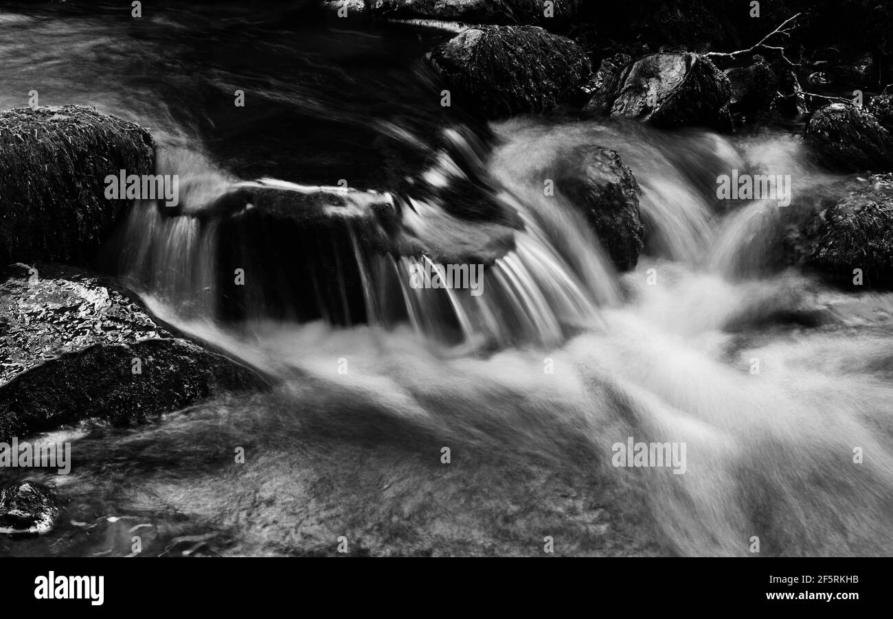Fast flowing river white water rocks valley mountains hi-res stock ...