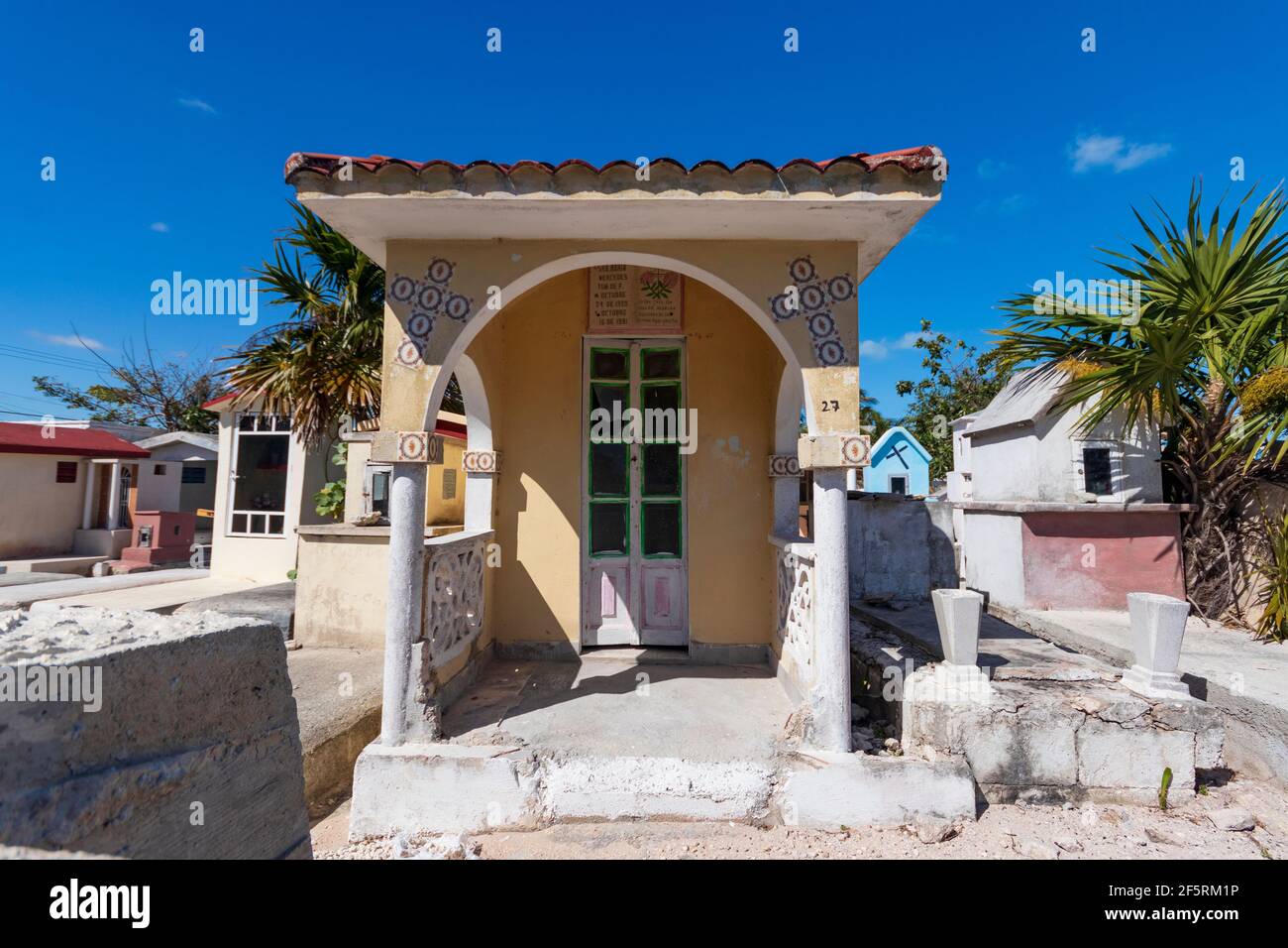 Colourful and elaborate monuments in a Mexican cemetery. People of ...