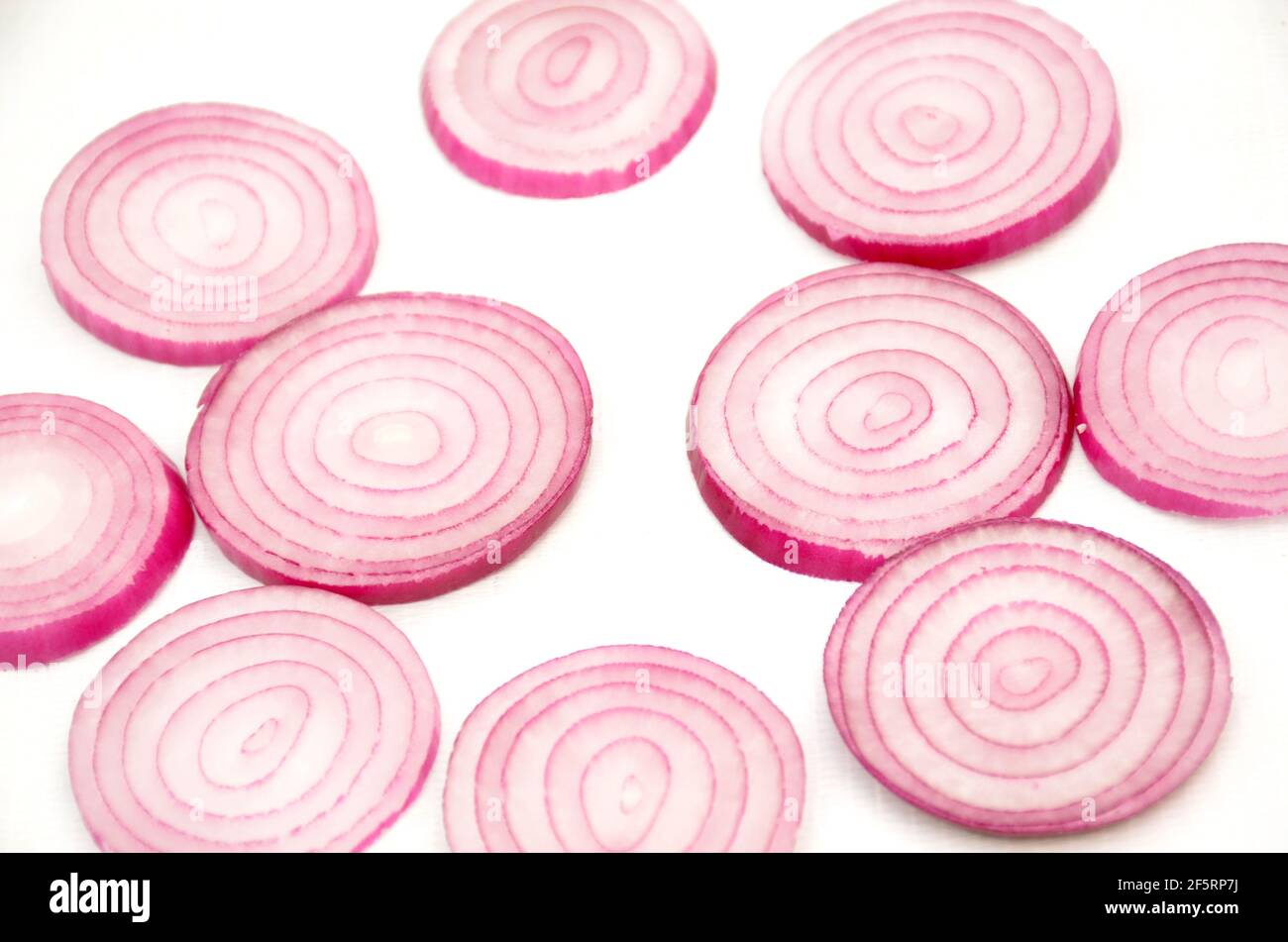 Freshly sliced onion rings on a white surface Stock Photo - Alamy