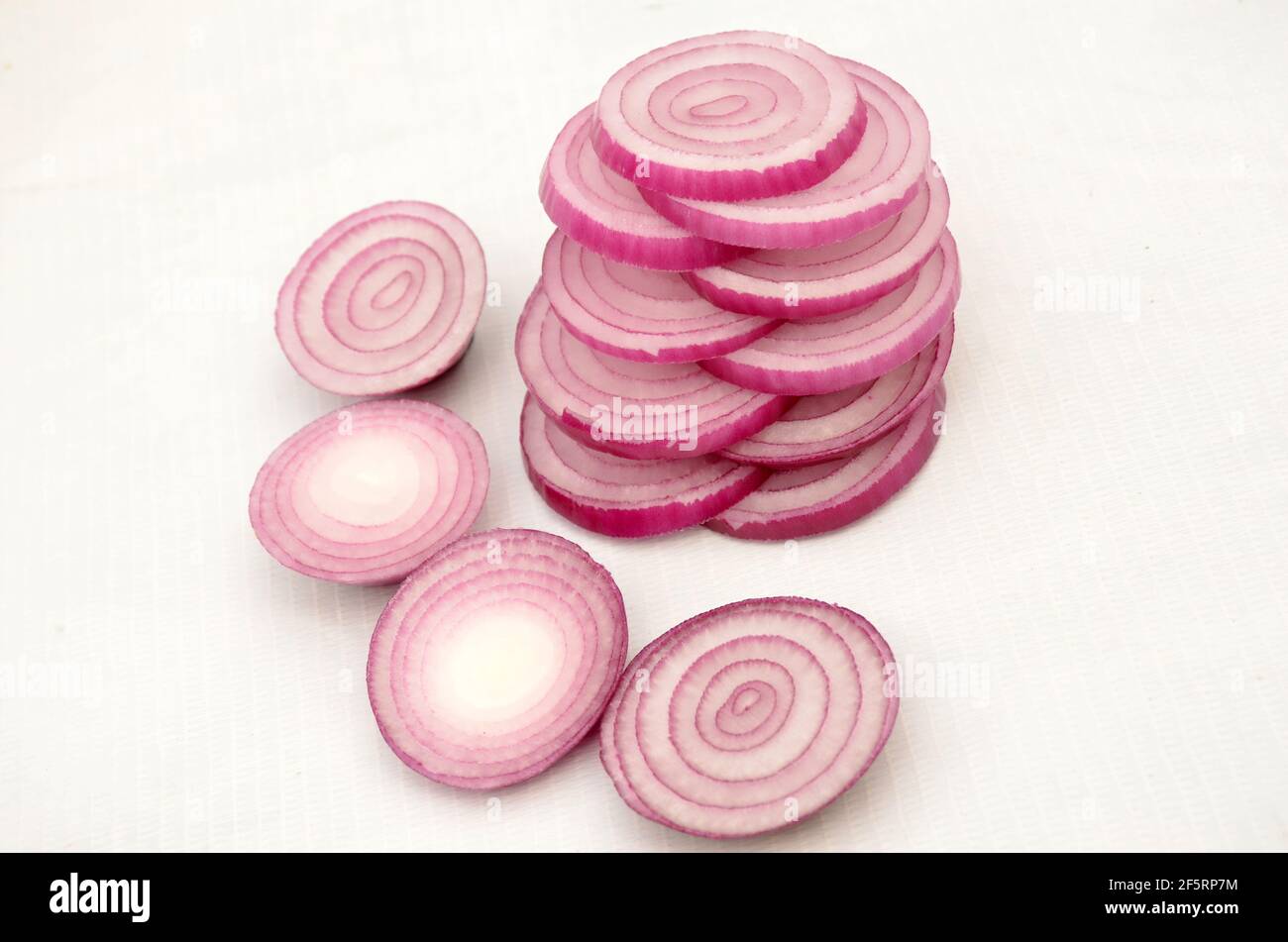 Freshly sliced onion rings on a white surface Stock Photo - Alamy