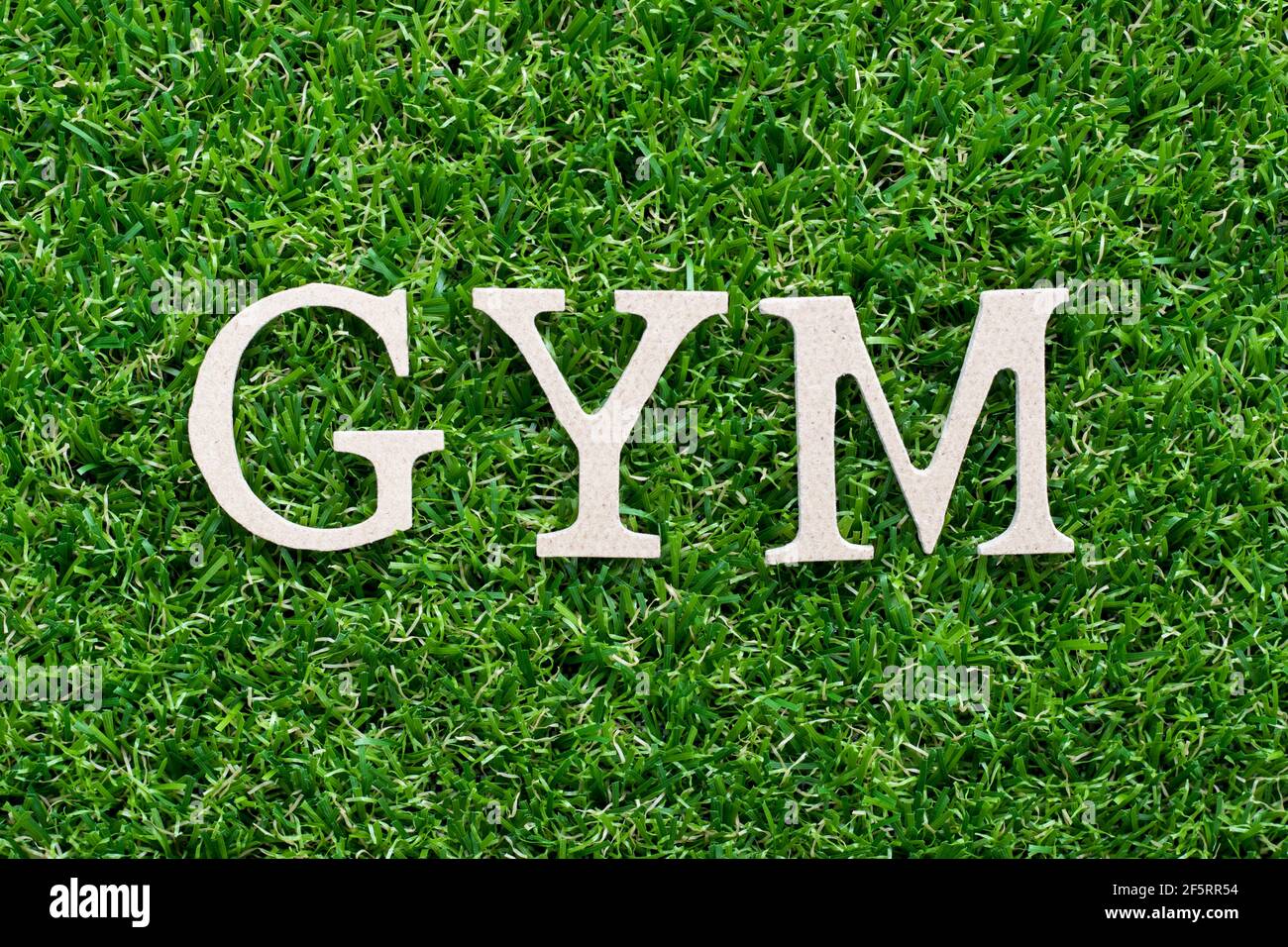 Wood alphabet in word gym on artificial green grass background Stock ...