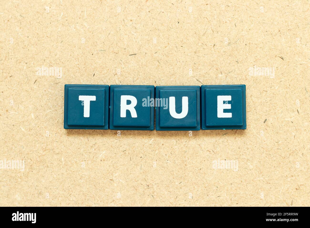 Tile alphabet letter in word true on wood background Stock Photo - Alamy