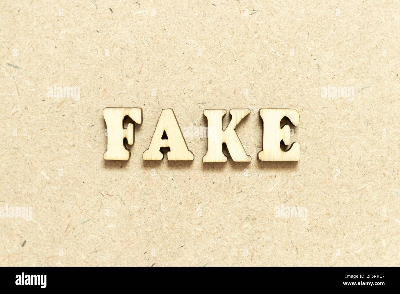 Alphabet letter in word fake on wood background Stock Photo - Alamy