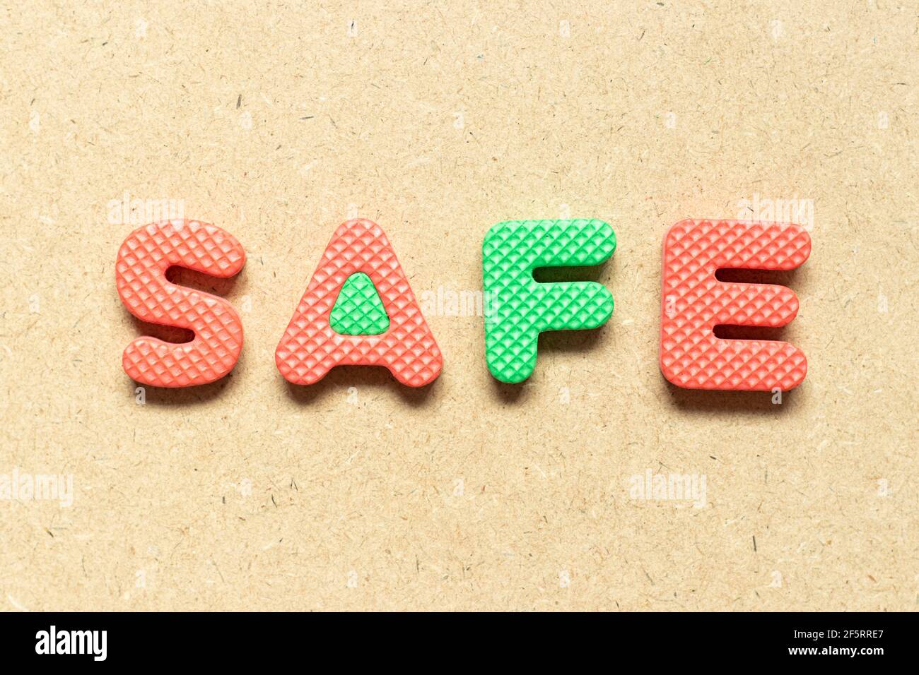 Foam alphabet letter in word safe on wood background Stock Photo - Alamy