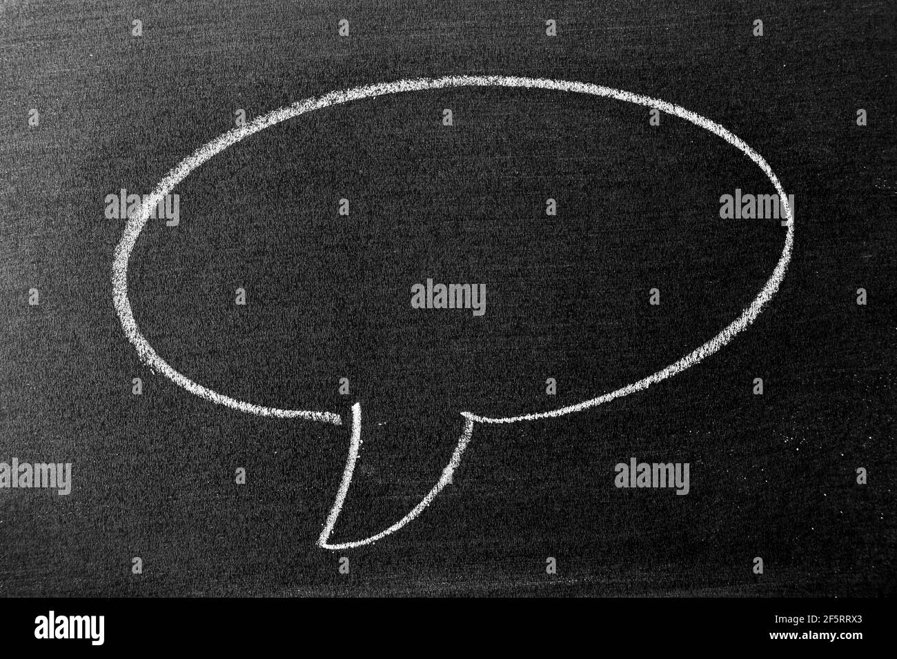 White color chalk hand drawing in round bubble speech shape with blank ...